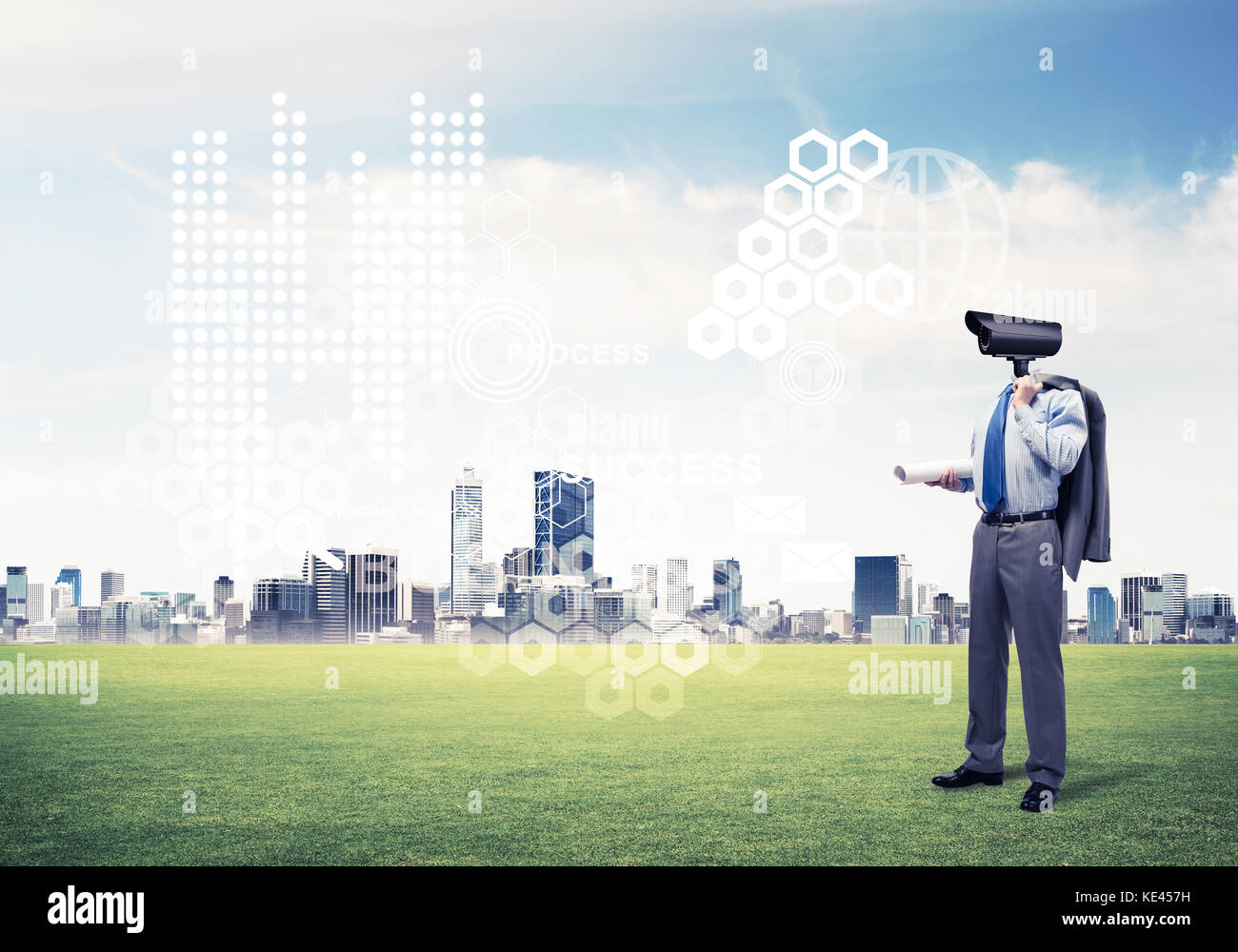Camera headed man standing on green grass against modern citysca Stock ...