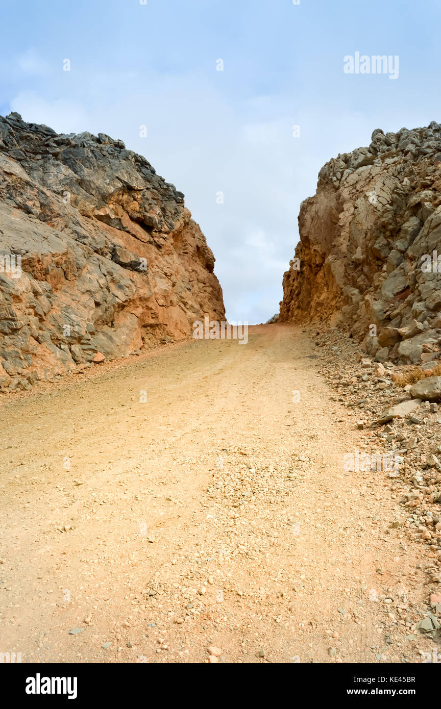 Dirt road dug in the hill in the mountains on the island of Crete Stock ...