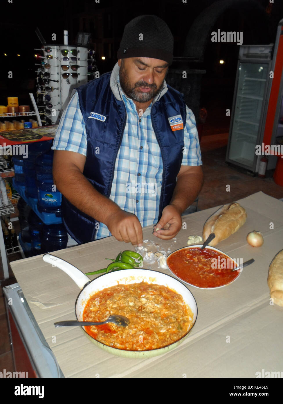 Local supermarket owner enjoying his evening meal of Chicken stew ...