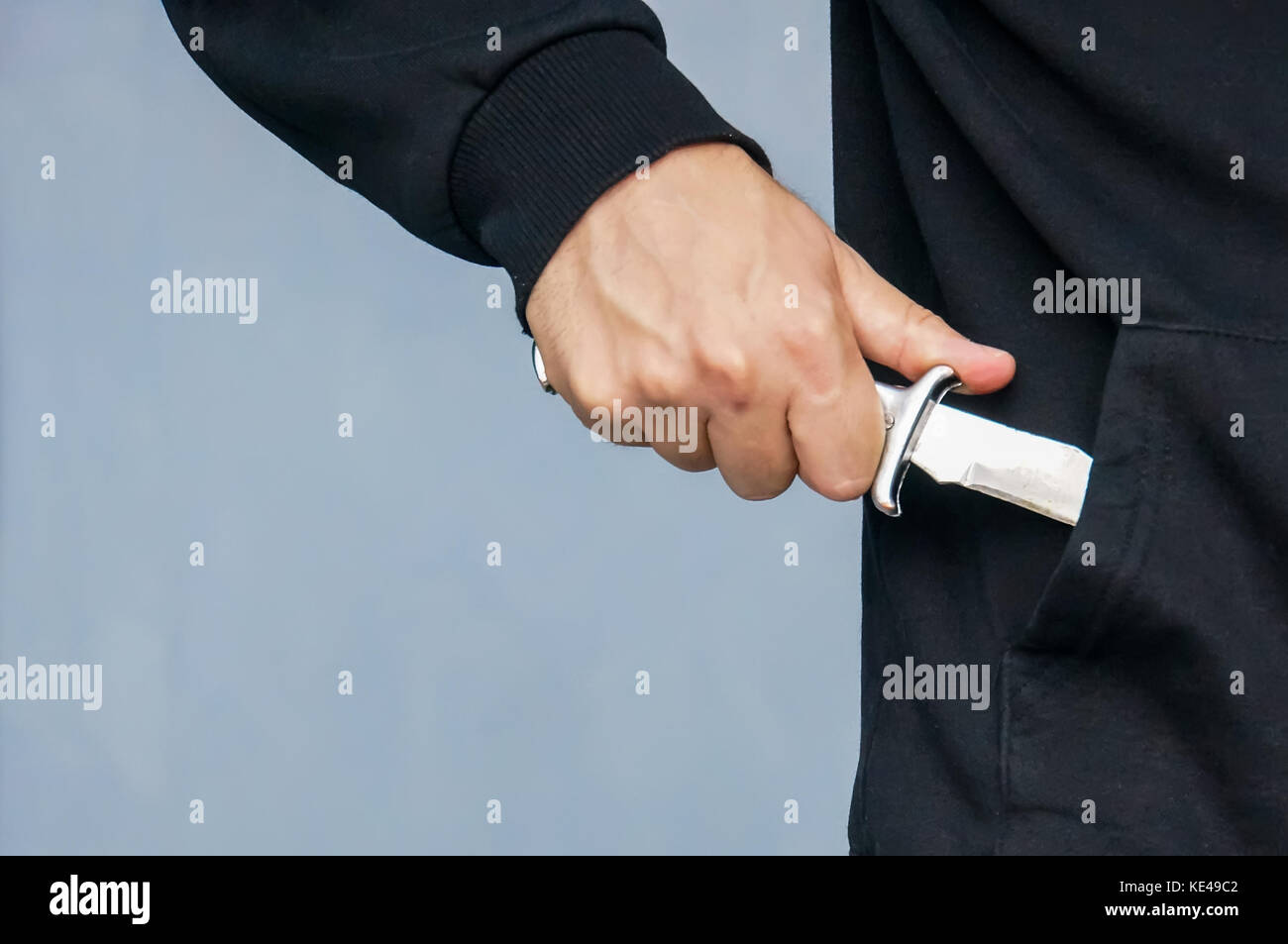 Hiding knife hi-res stock photography and images - Alamy