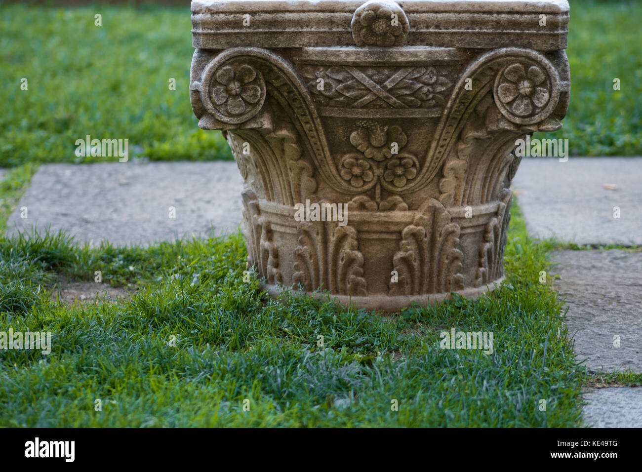 Column capital on earth Museum exhibit Stock Photo - Alamy