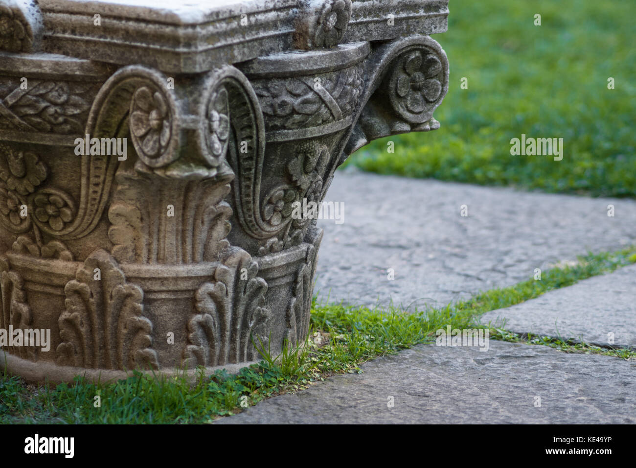 Column capital on earth Museum exhibit Stock Photo - Alamy