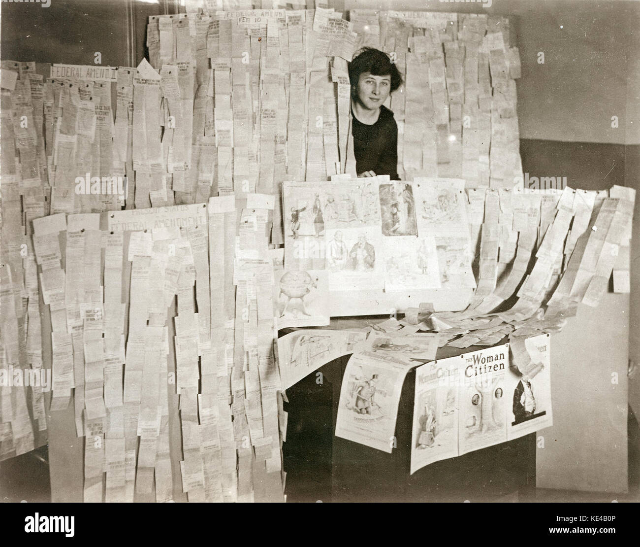 Suffrage worker with newspaper clippings on the passage of the ...