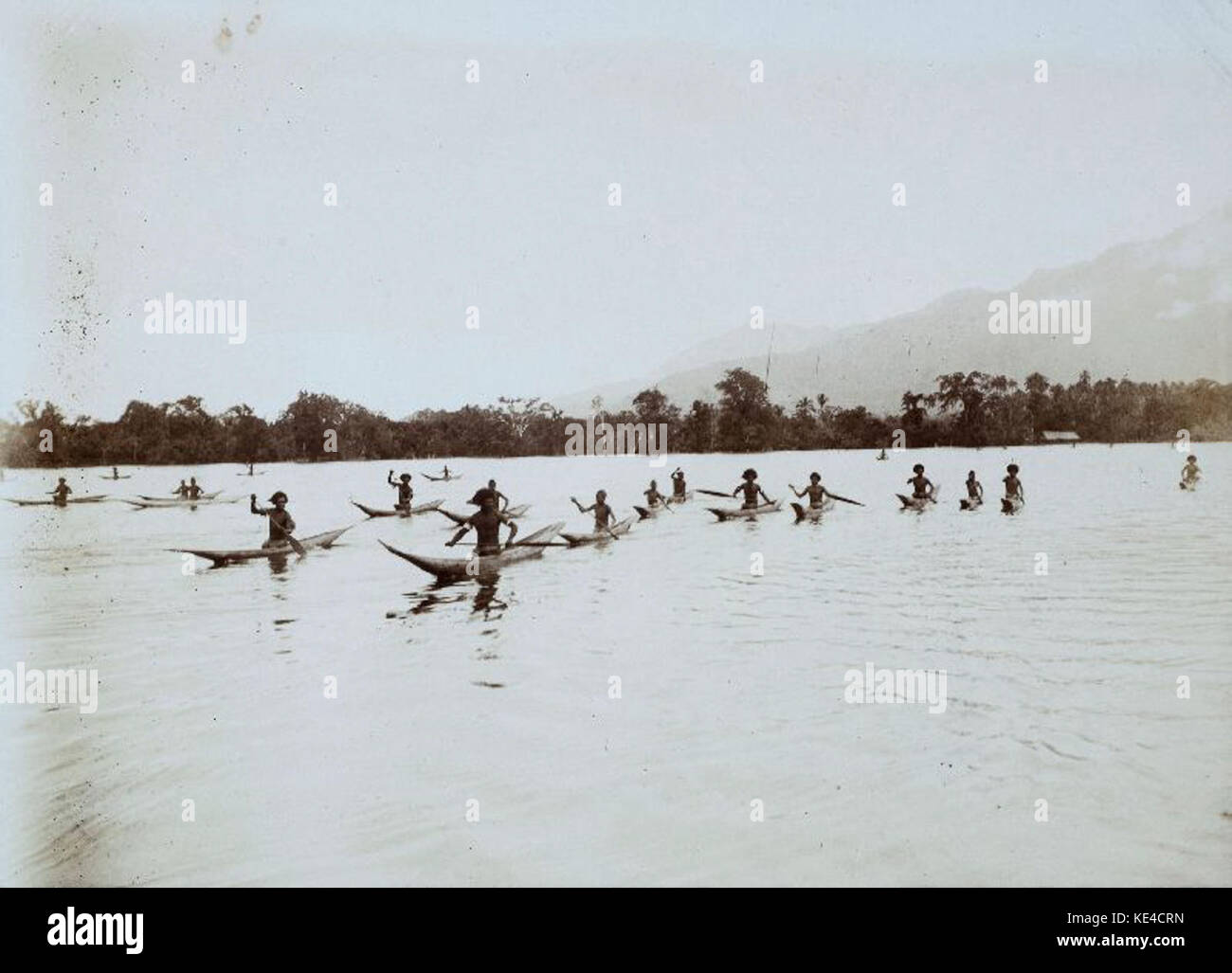 This image shows Papuans navigating in proas on Lake Sentani, located ...