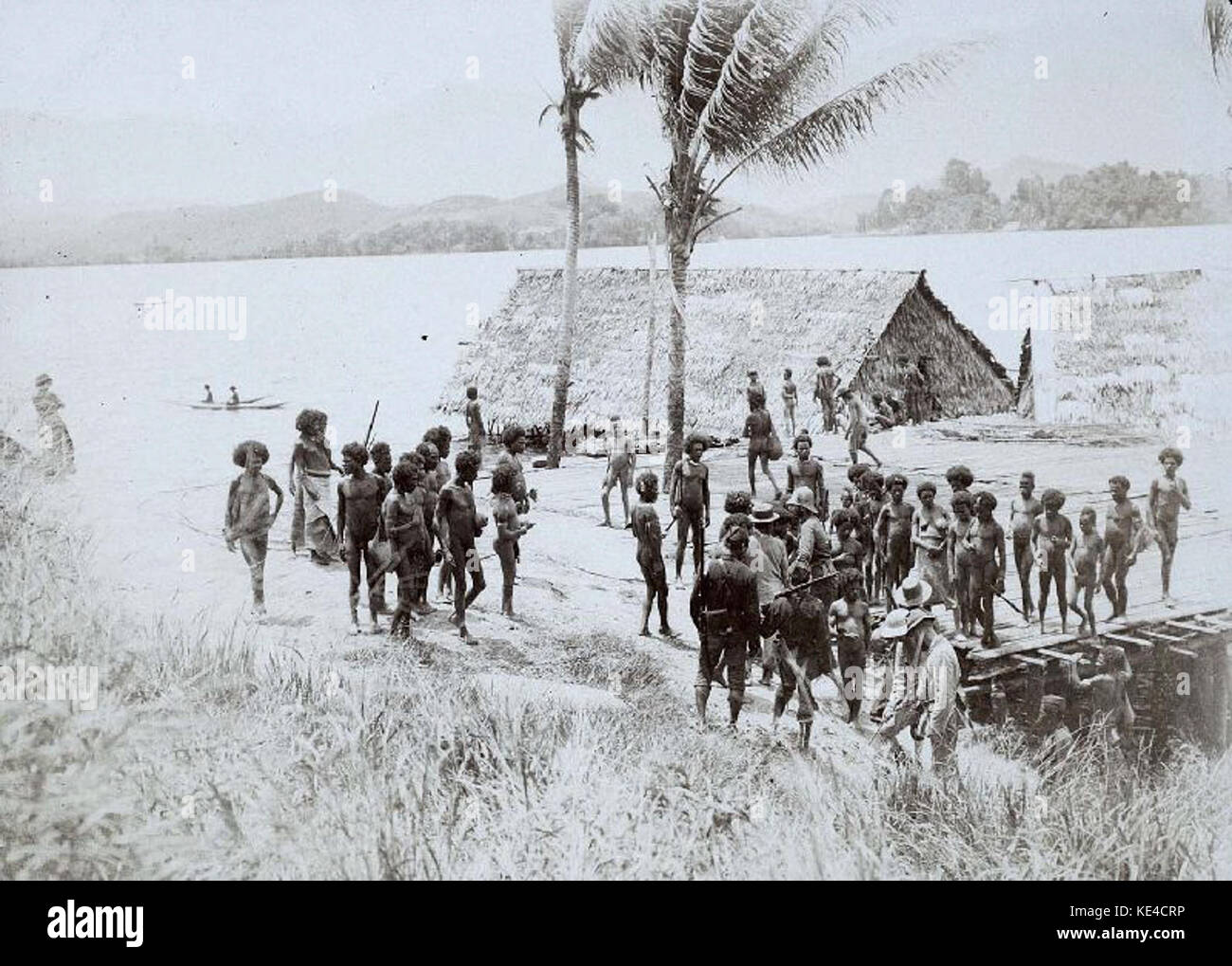 Expedition members meeting Papuan people in a village at Lake Sentani ...