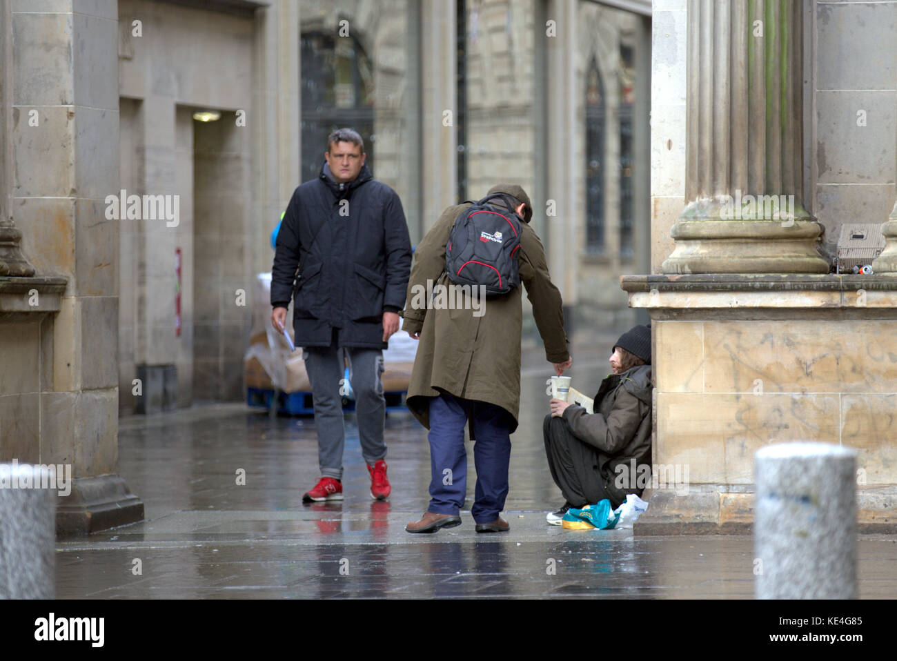 Man Giving Money To Homeless
