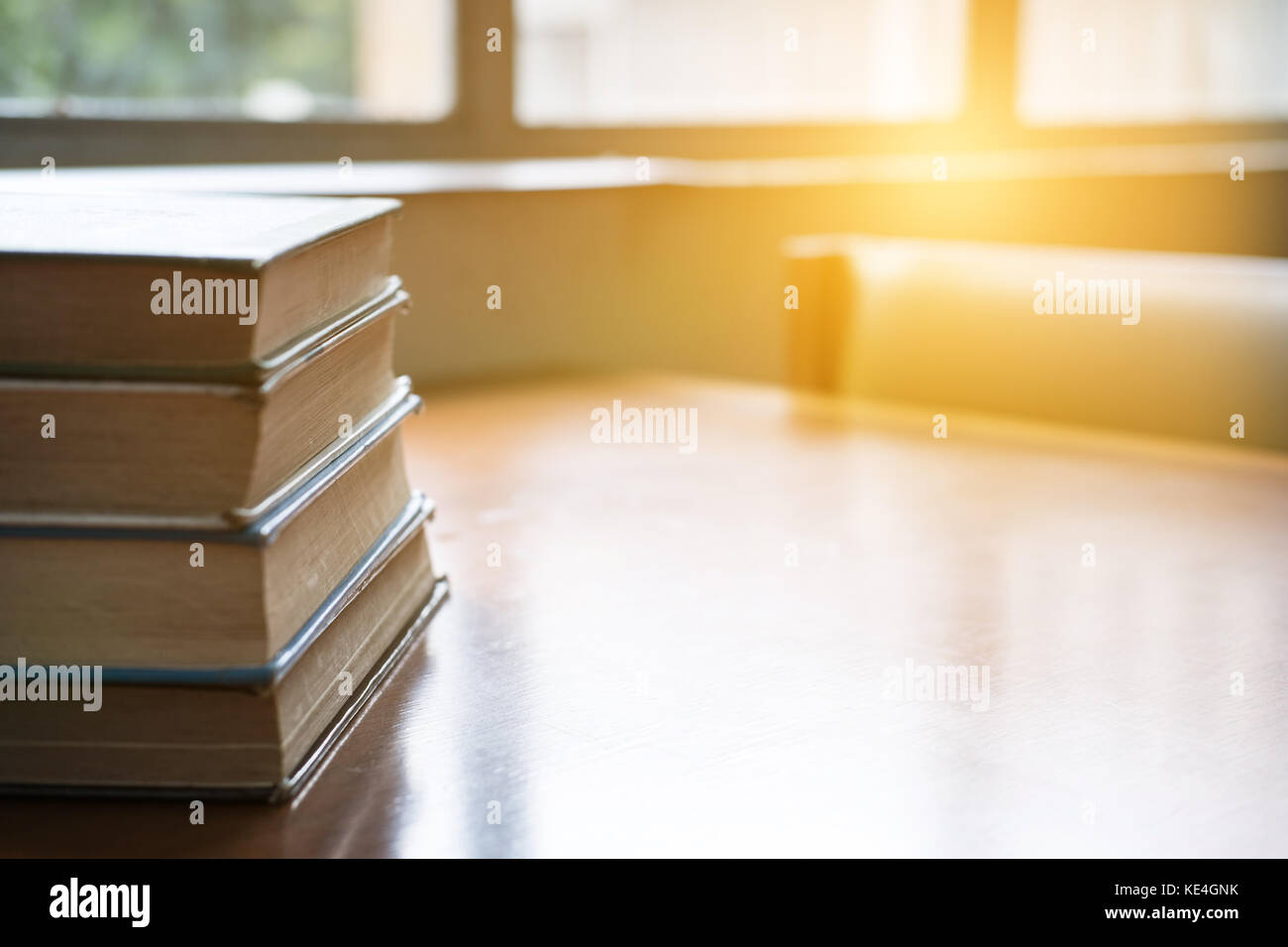 old book on wood table. textbook beside window. education, study ...