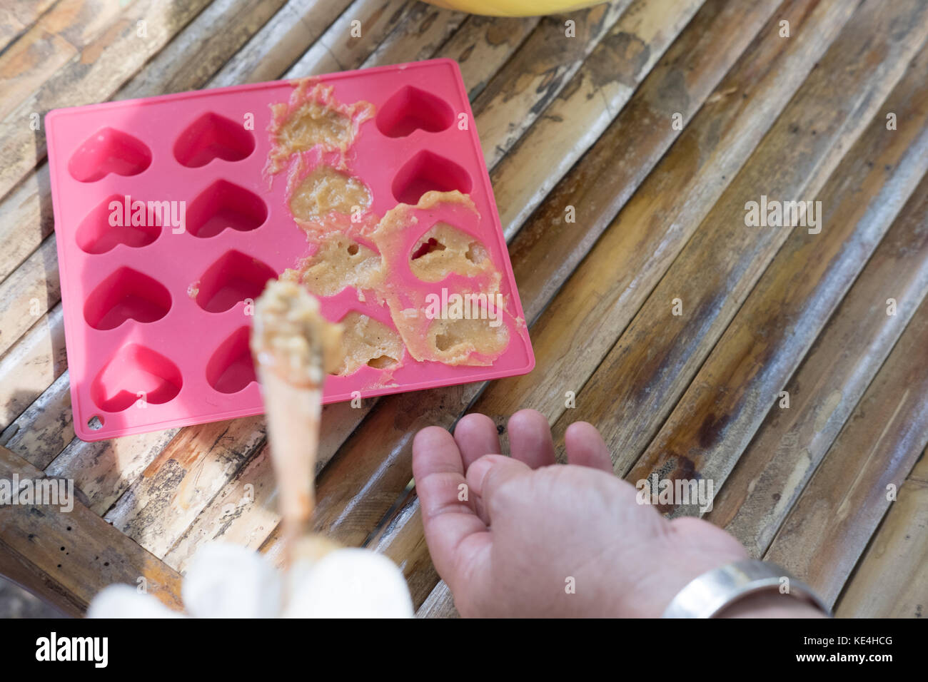 people pour soap into silicone mold. hand making handmade natural soap ...