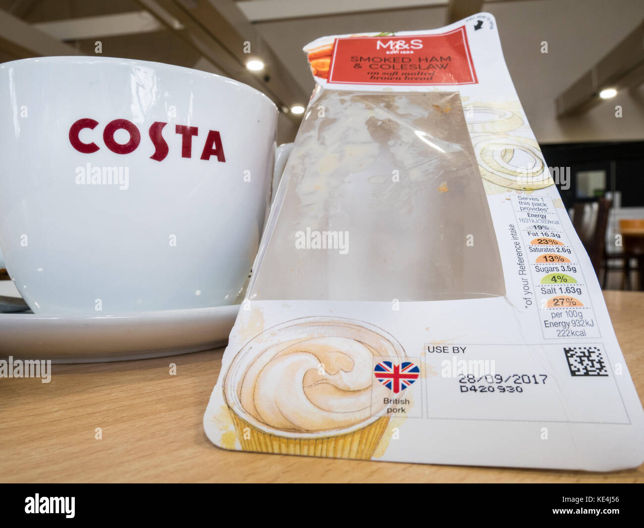 Costa coffee mug and empty M&S sandwich wrapping on the table of a cafe ...