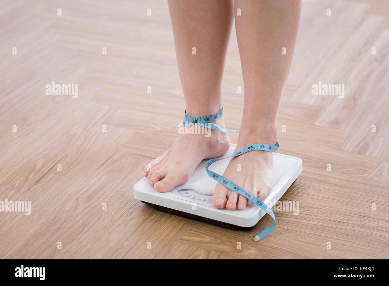 Fat woman standing on a scale Stock Photo - Alamy