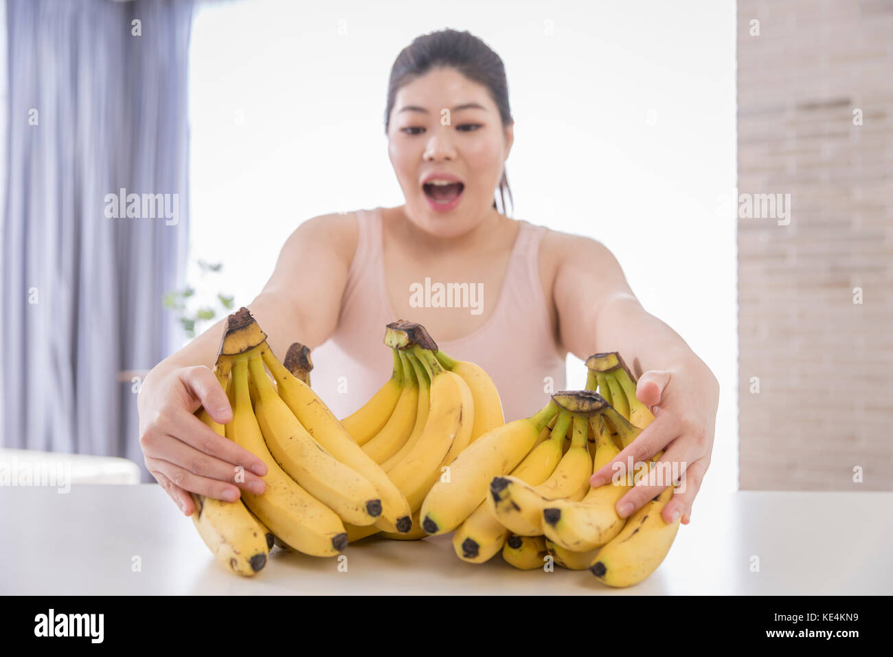 Portrait of young fat woman surprised with bananas Stock Photo - Alamy