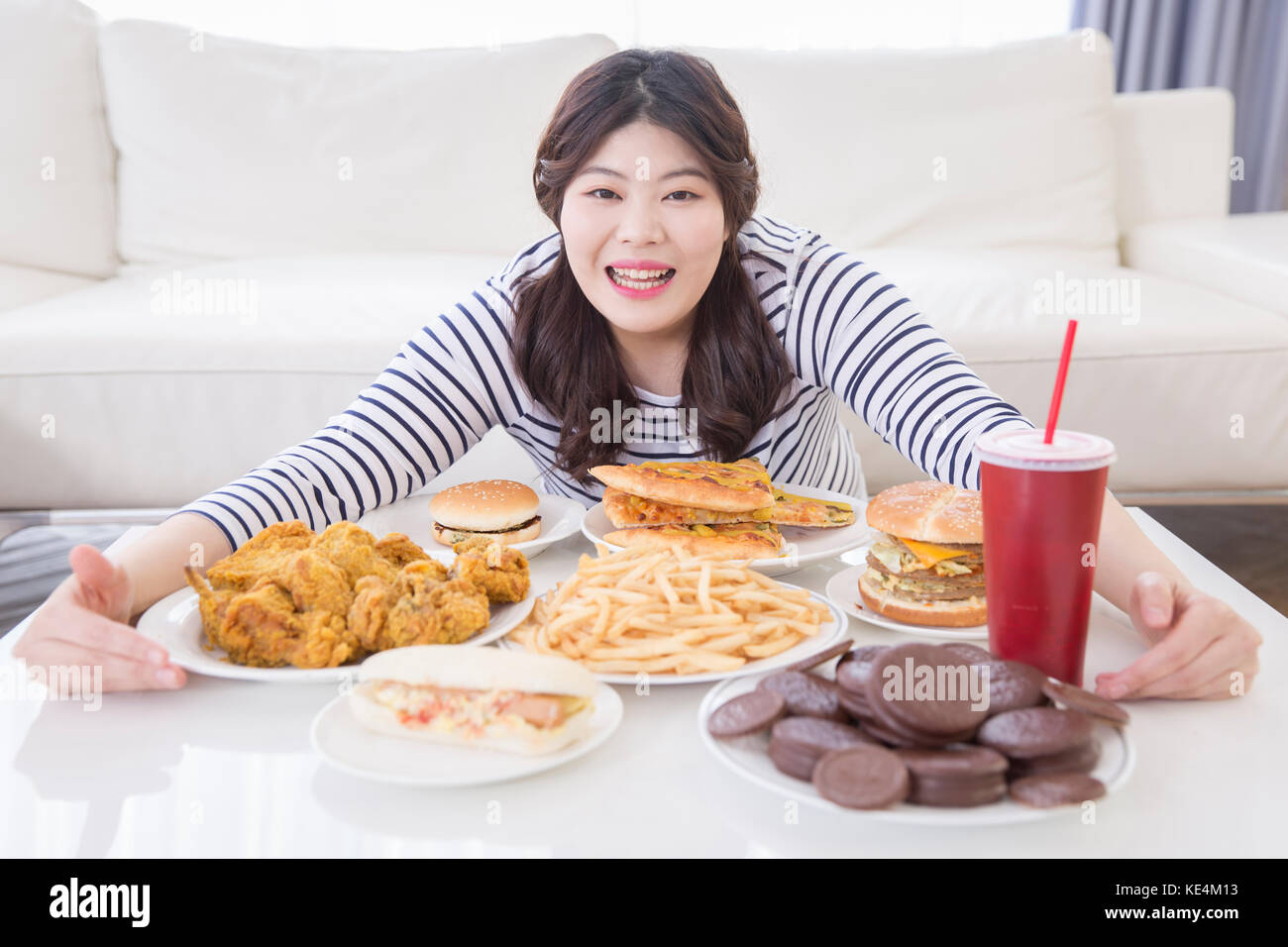 Portrait of young smiling fat woman with fast food Stock Photo - Alamy