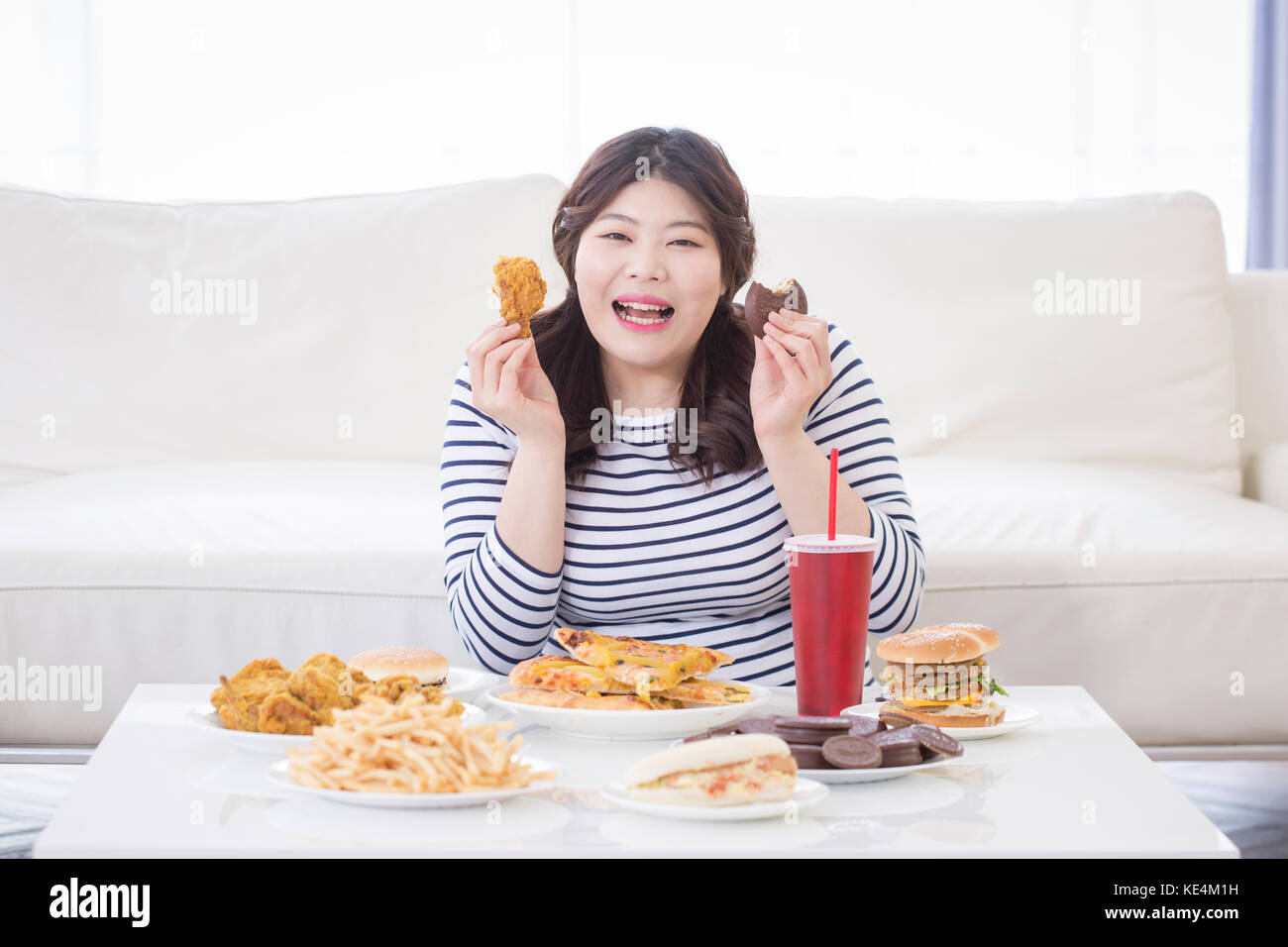 Portrait of young smiling fat woman eating fast food Stock Photo - Alamy