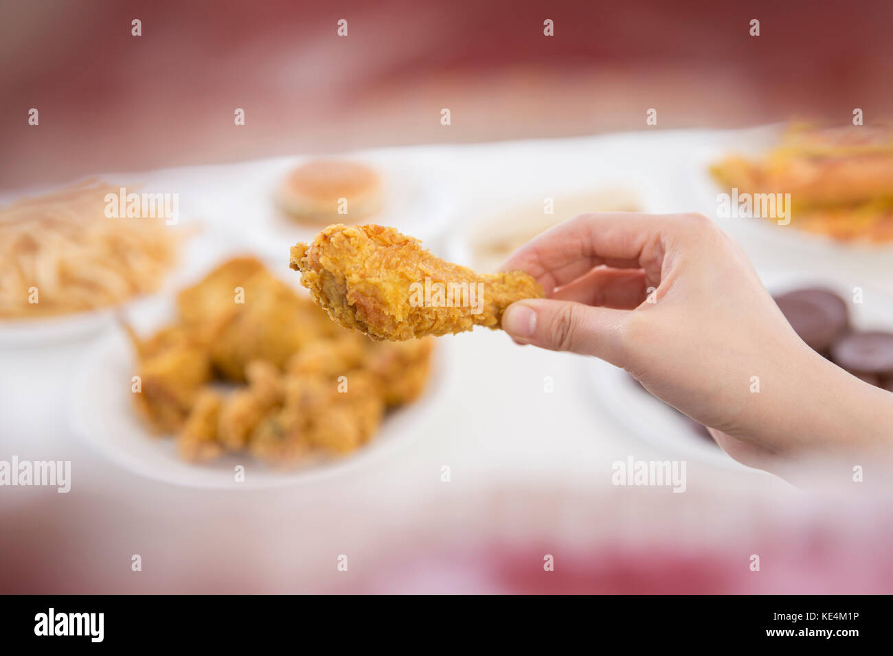 Hand holding fast food Stock Photo - Alamy