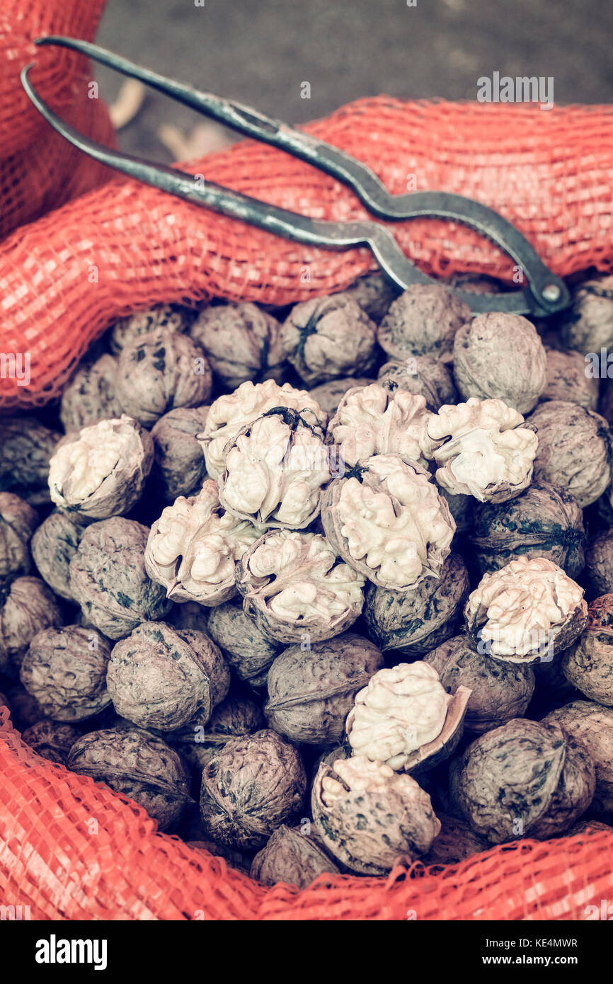 Vintage toned close up picture of walnuts in a bag on a local market ...