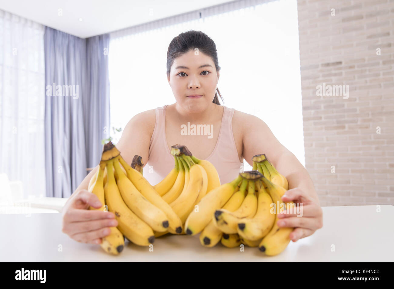 Po2 of young fat woman with bananas Stock Photo - Alamy