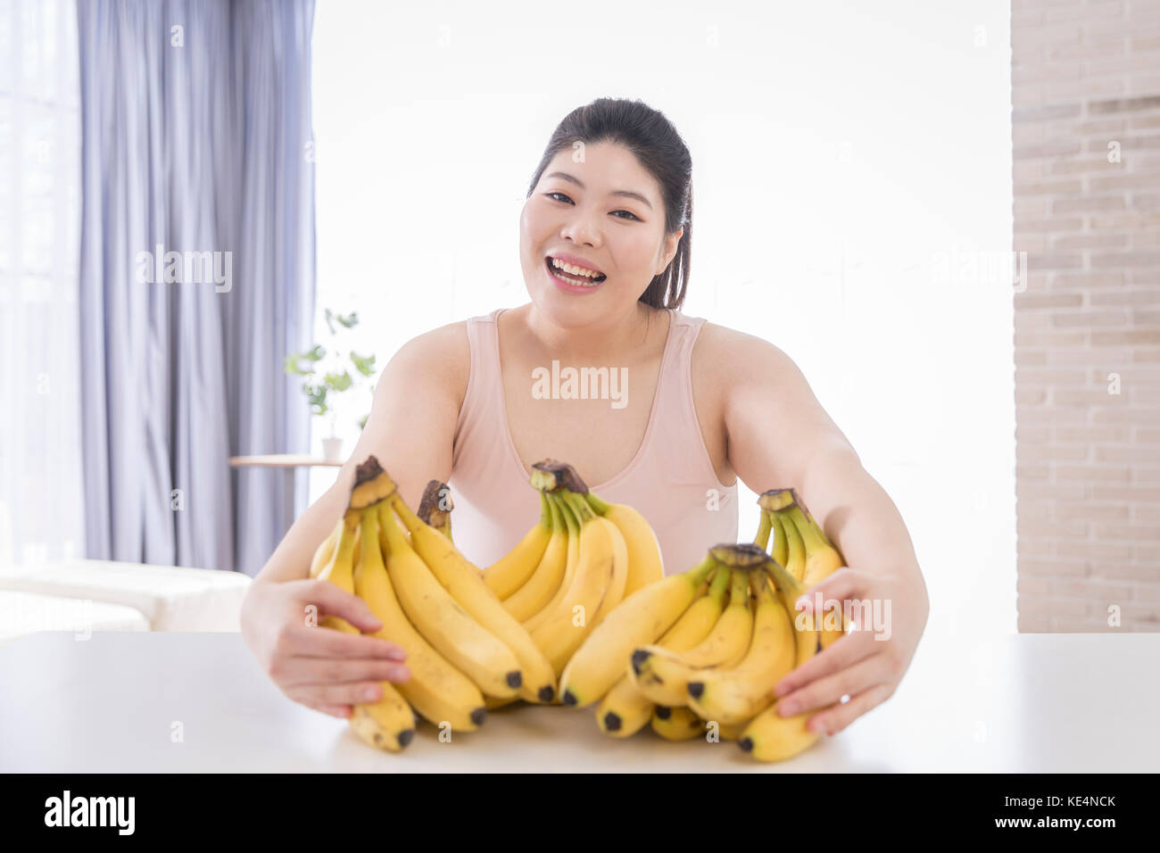 Portrait of young smiling fat woman with bananas Stock Photo - Alamy