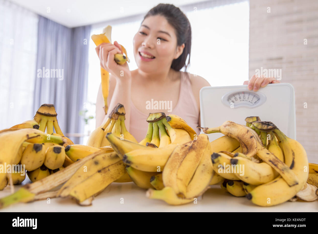 Portrait of young smiling fat woman with bananas and a scale Stock ...