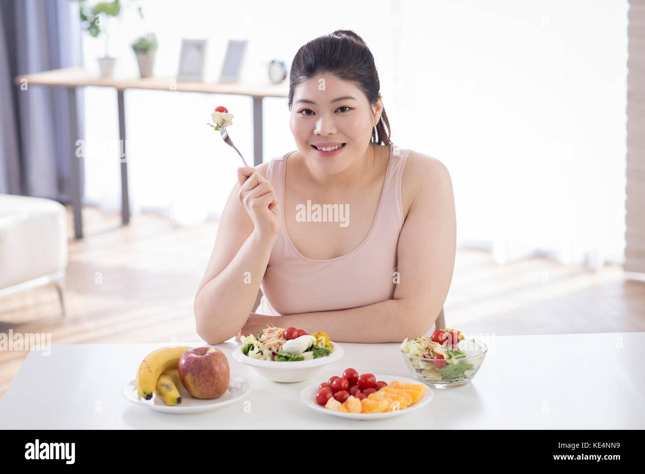 Portrait of young smiling fat woman with fruits and vegetables Stock ...