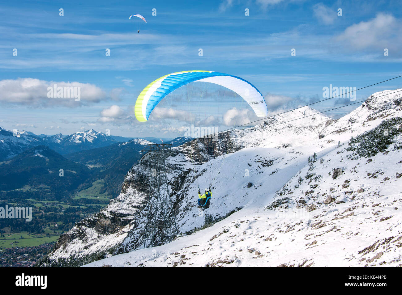 Paraglider flying from snow covered Nebelhorn to Oberstdorf in ...