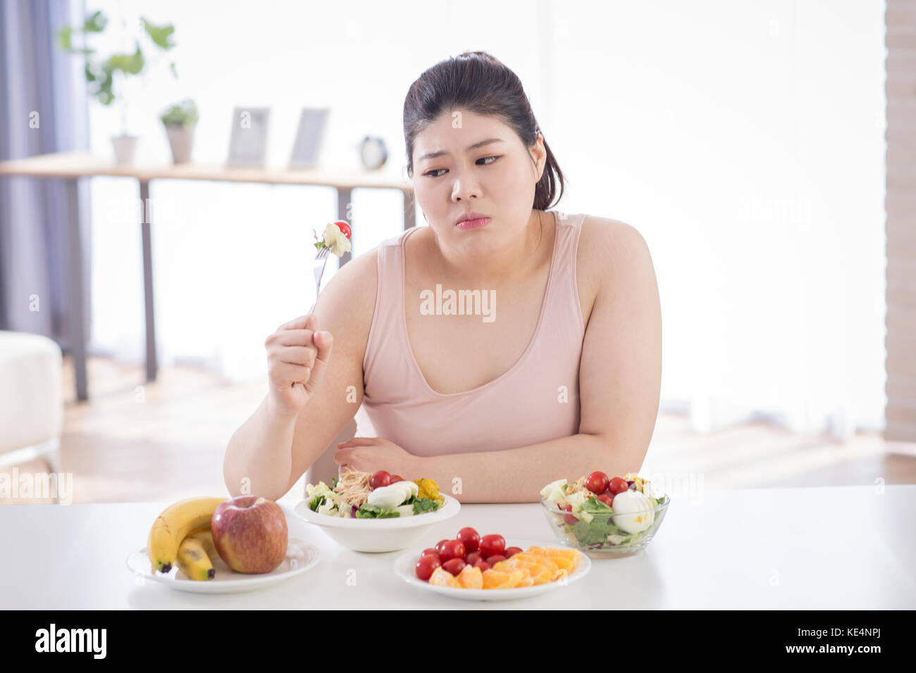Portrait of stressful fat woman eating vegetable salad Stock Photo - Alamy
