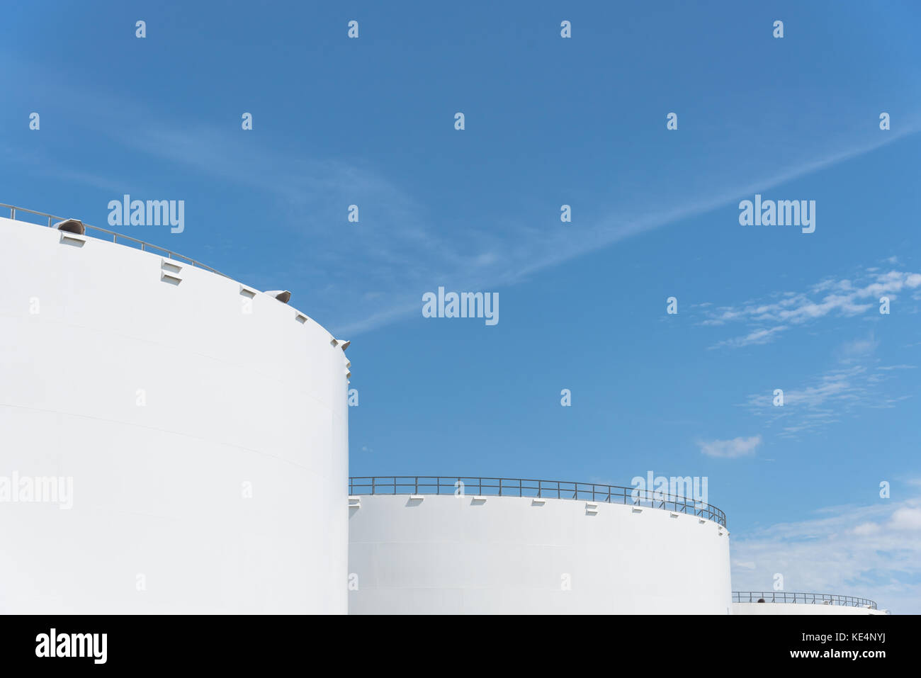 Oil tanks in a row under blue sky in Pasadena, Texas, USA. Large white ...