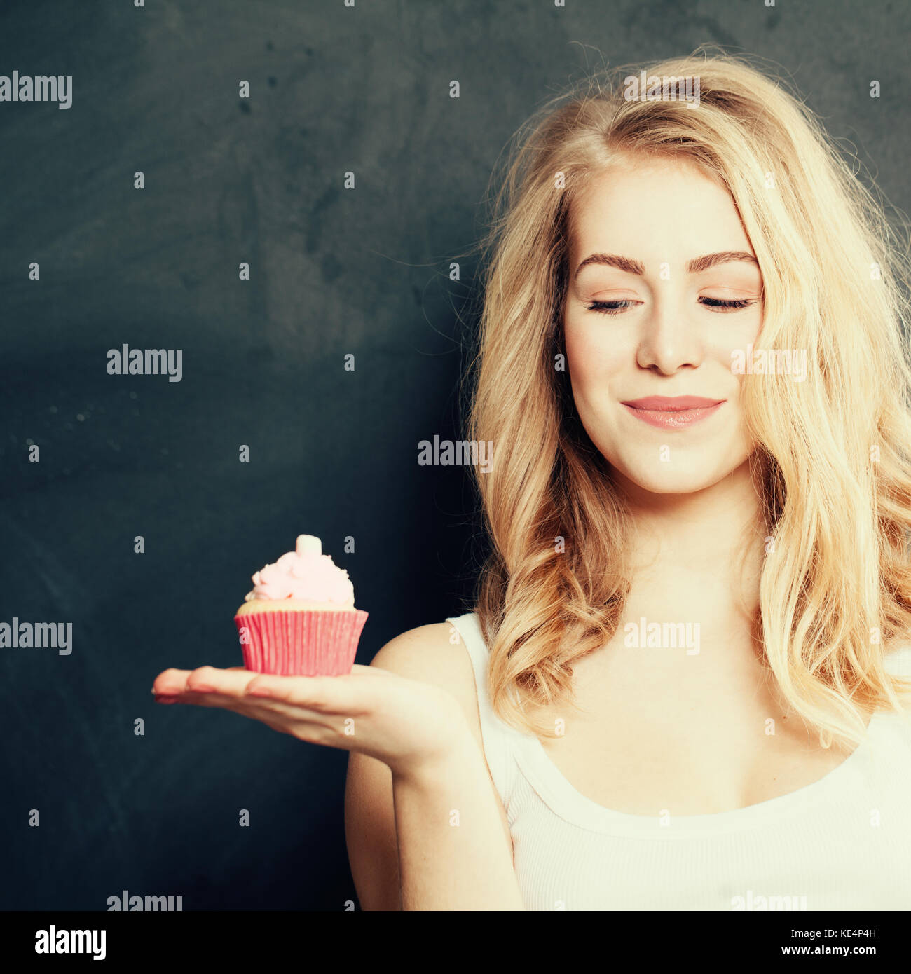 Beautiful smiling young woman with a cake Stock Photo - Alamy