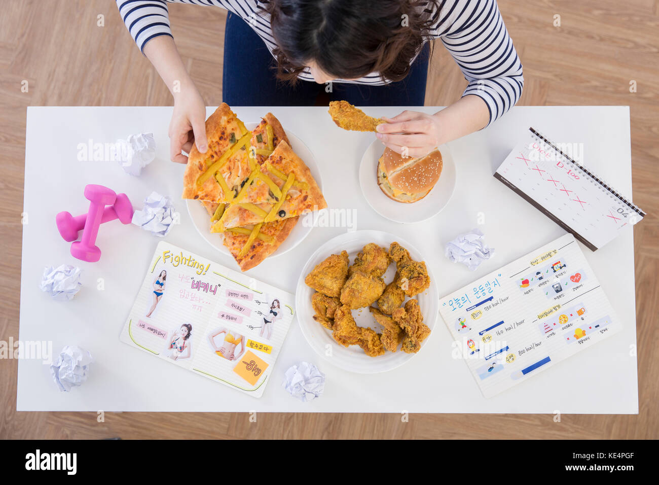 High angle view of young woman overeating fast-food Stock Photo - Alamy