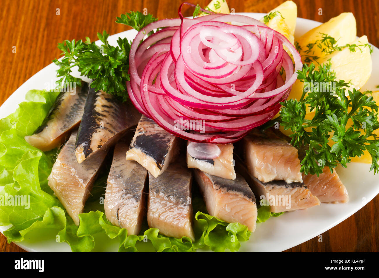 Herring fillet with potato served red onion Stock Photo - Alamy