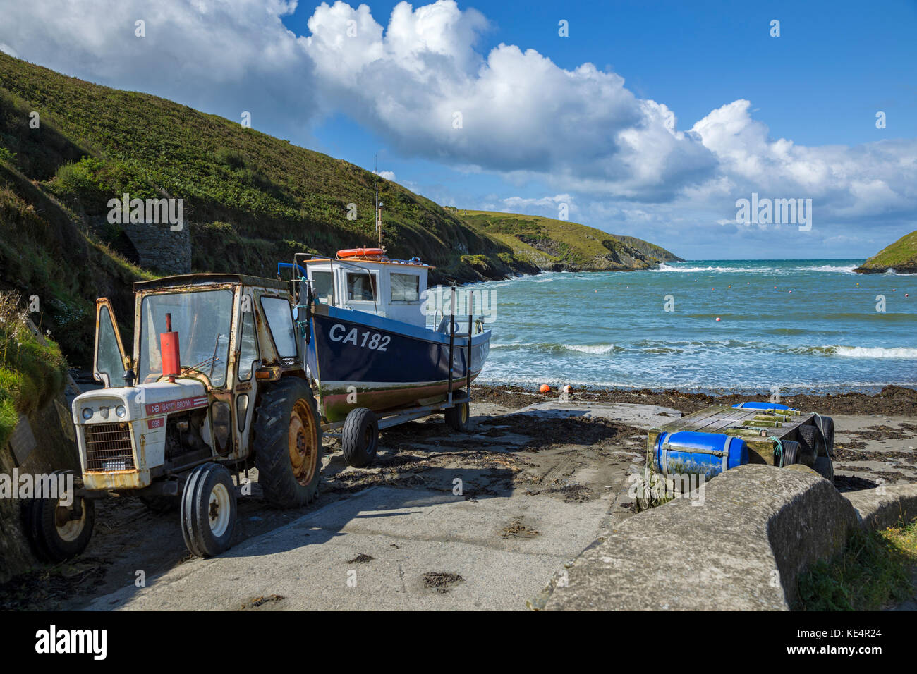 Small fishing boat on a trailer pulled by a vintage tractor Stock Photo ...