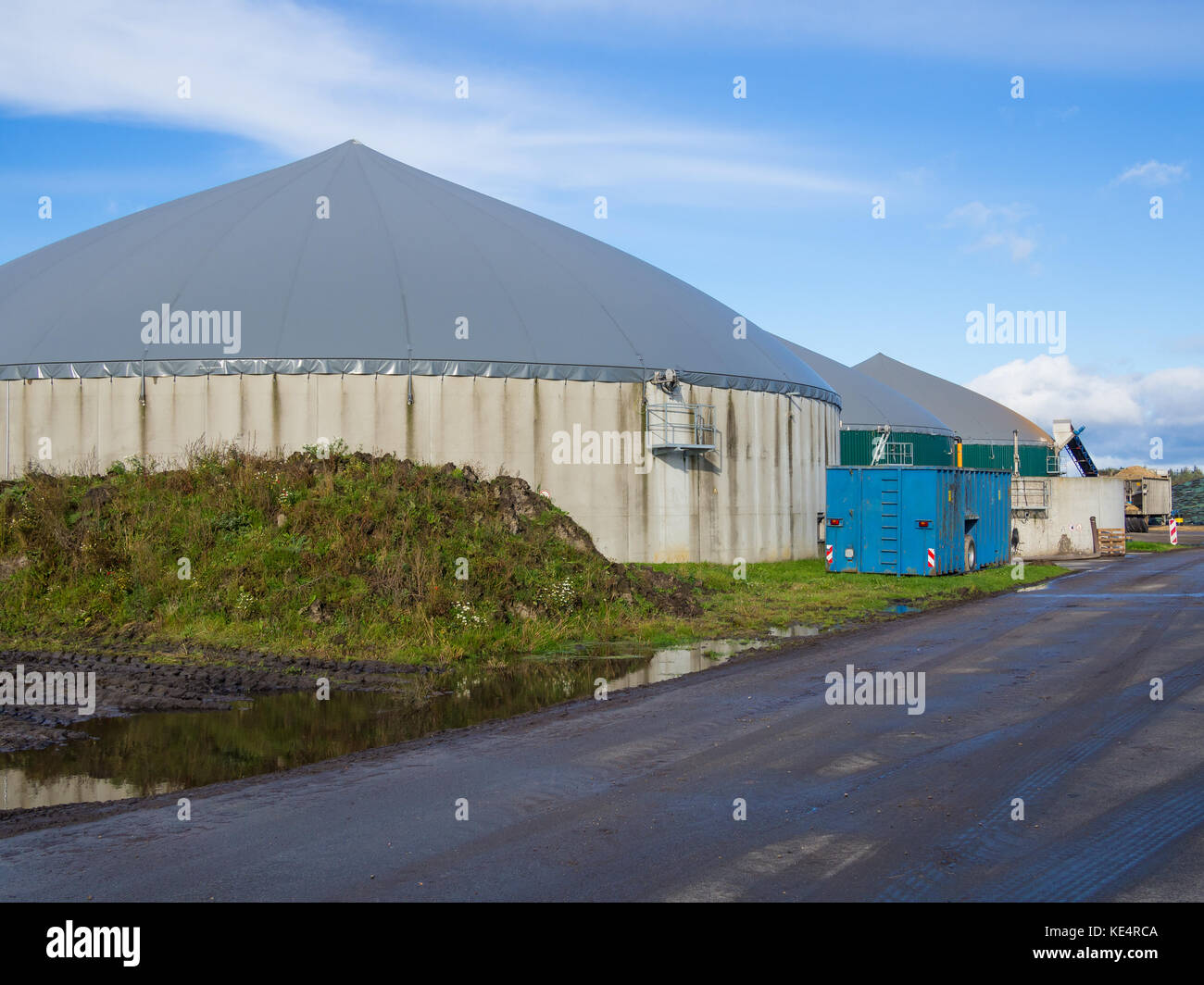 Biogas energy plant on farm in countryside with blue sky, Schleswig ...