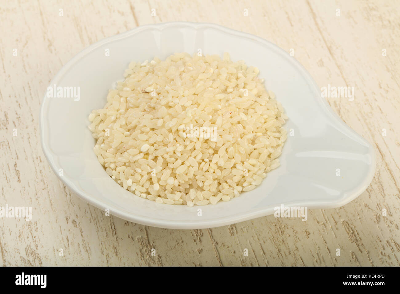 Raw rice heap in the bowl - ready for cooking Stock Photo - Alamy