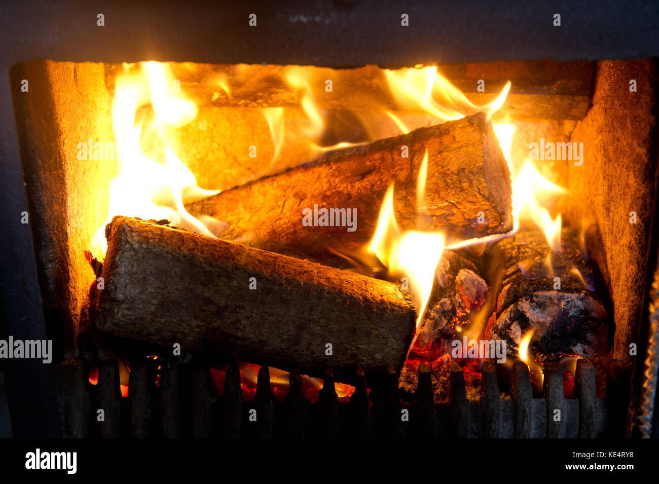 Logs burning in a logburner fire Stock Photo - Alamy