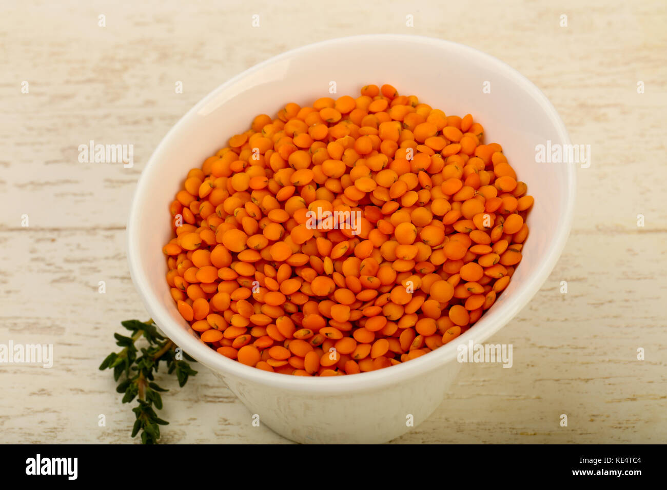 Orange lentil in the bowl over wooden background Stock Photo - Alamy