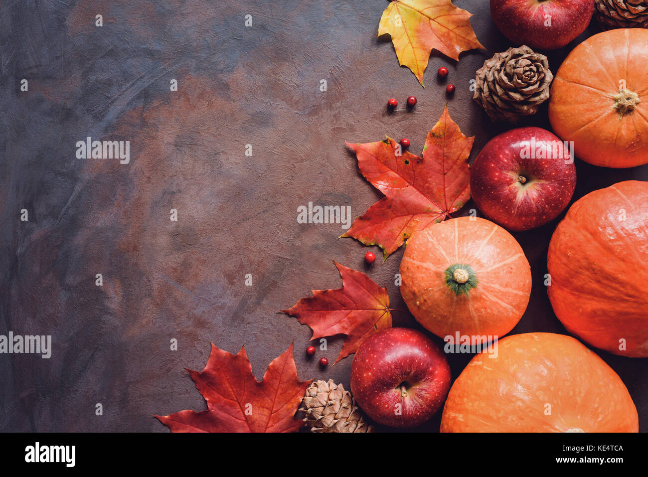 Autumn food background with pumpkins harvest, apples, red berries and ...