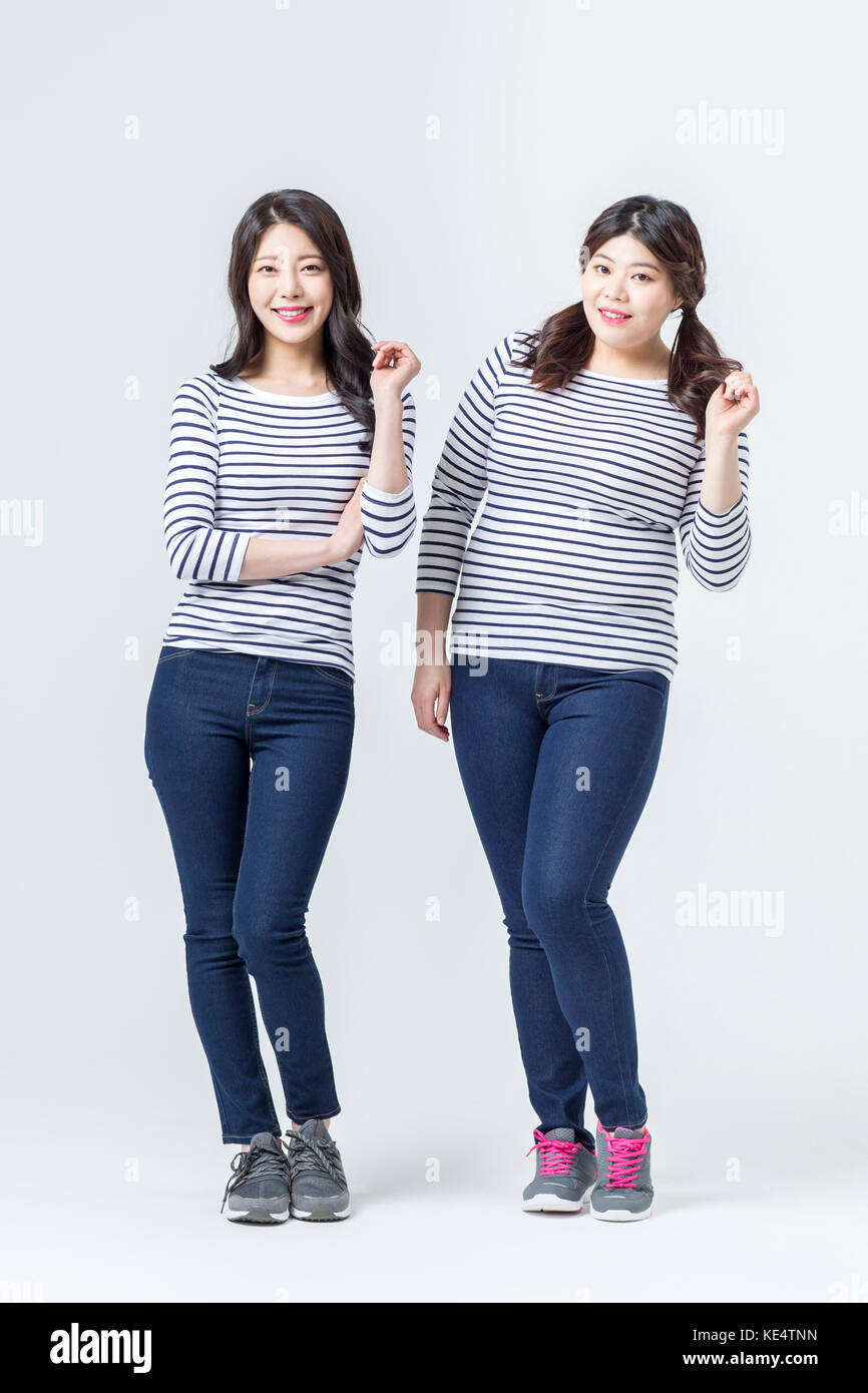 Two young smiling women slim and fat Stock Photo - Alamy