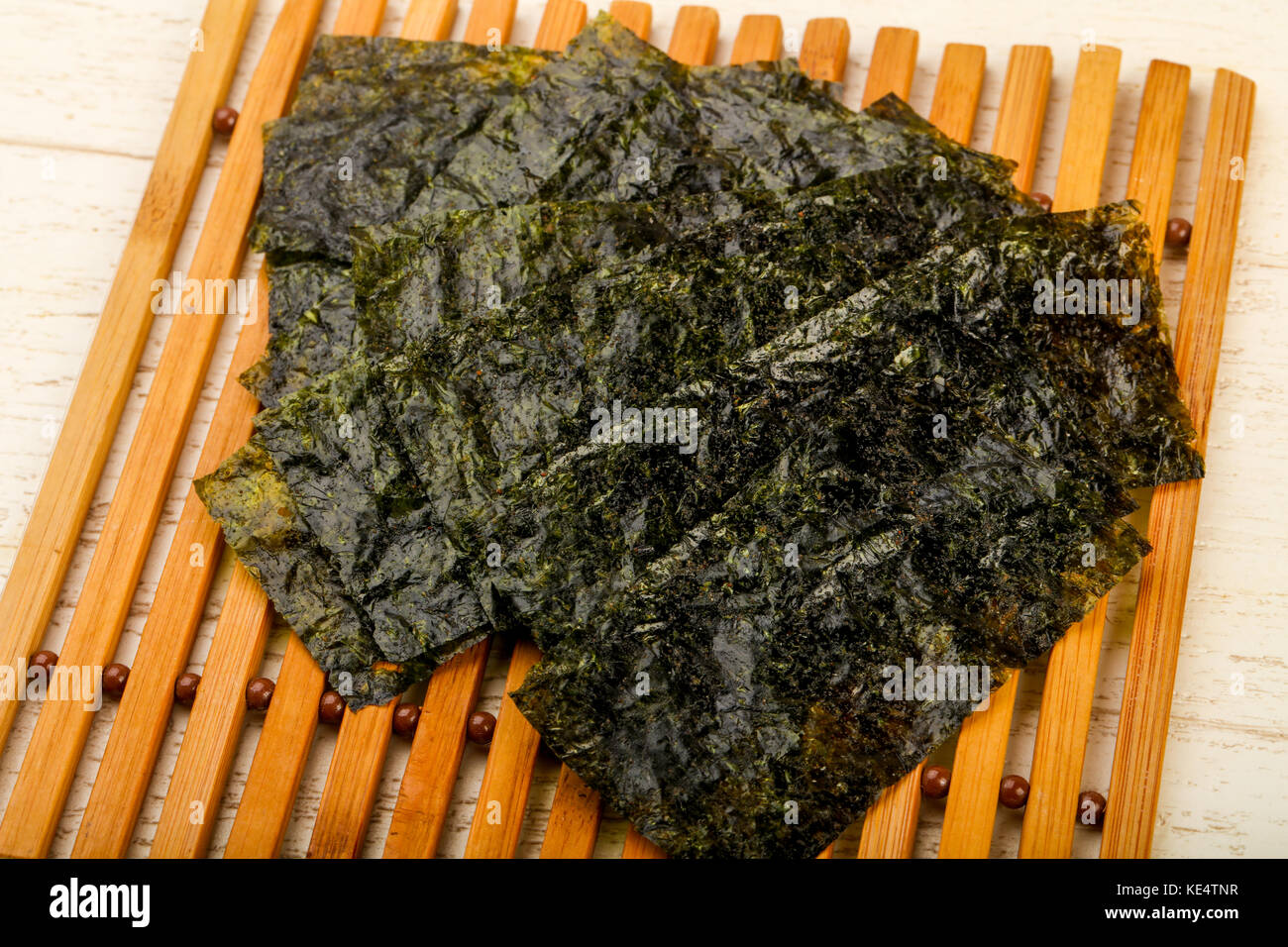 Crispy Nori sheets chips over wooden background Stock Photo - Alamy
