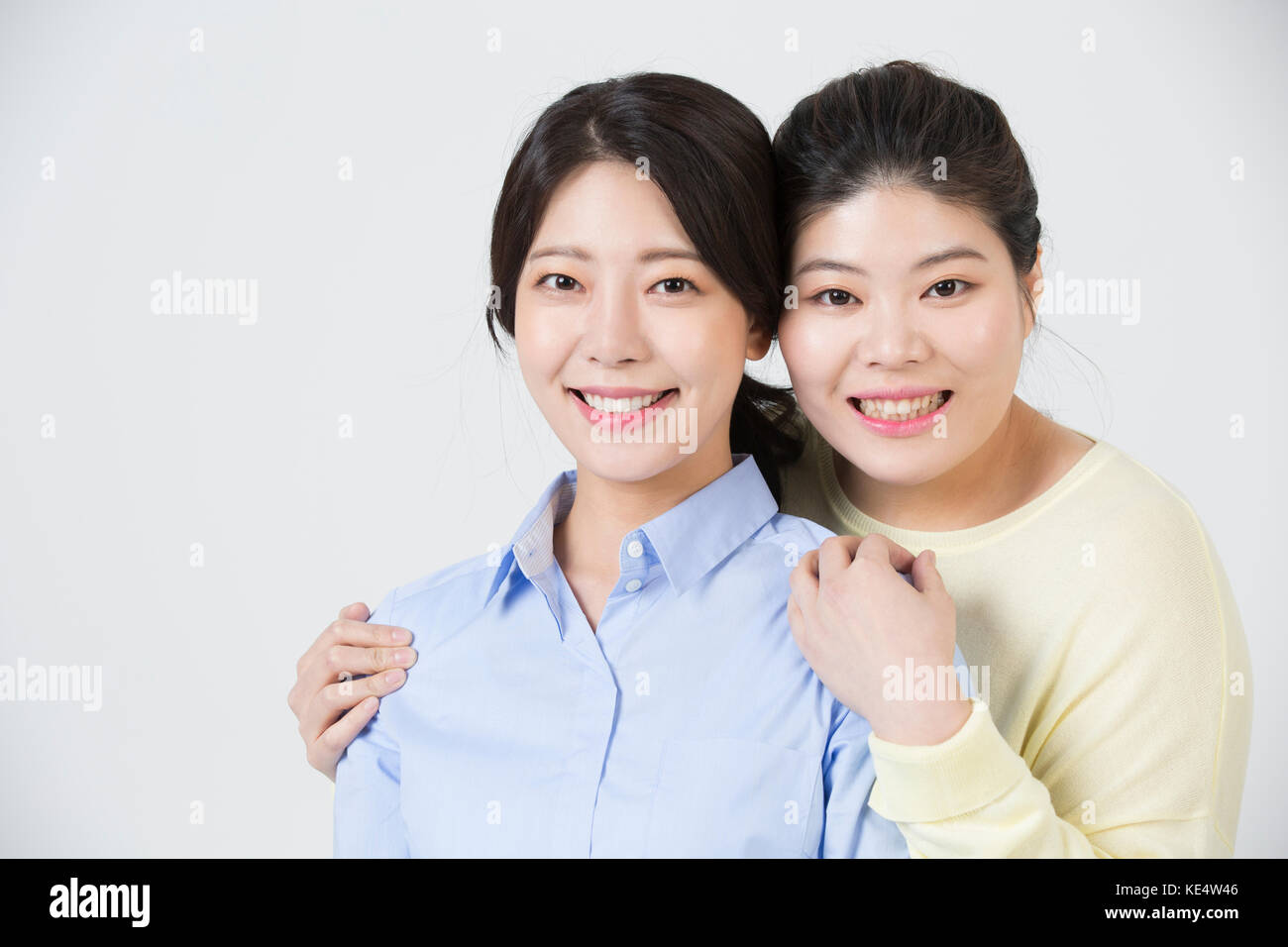 Portrait of two smiling women slim and fat Stock Photo - Alamy