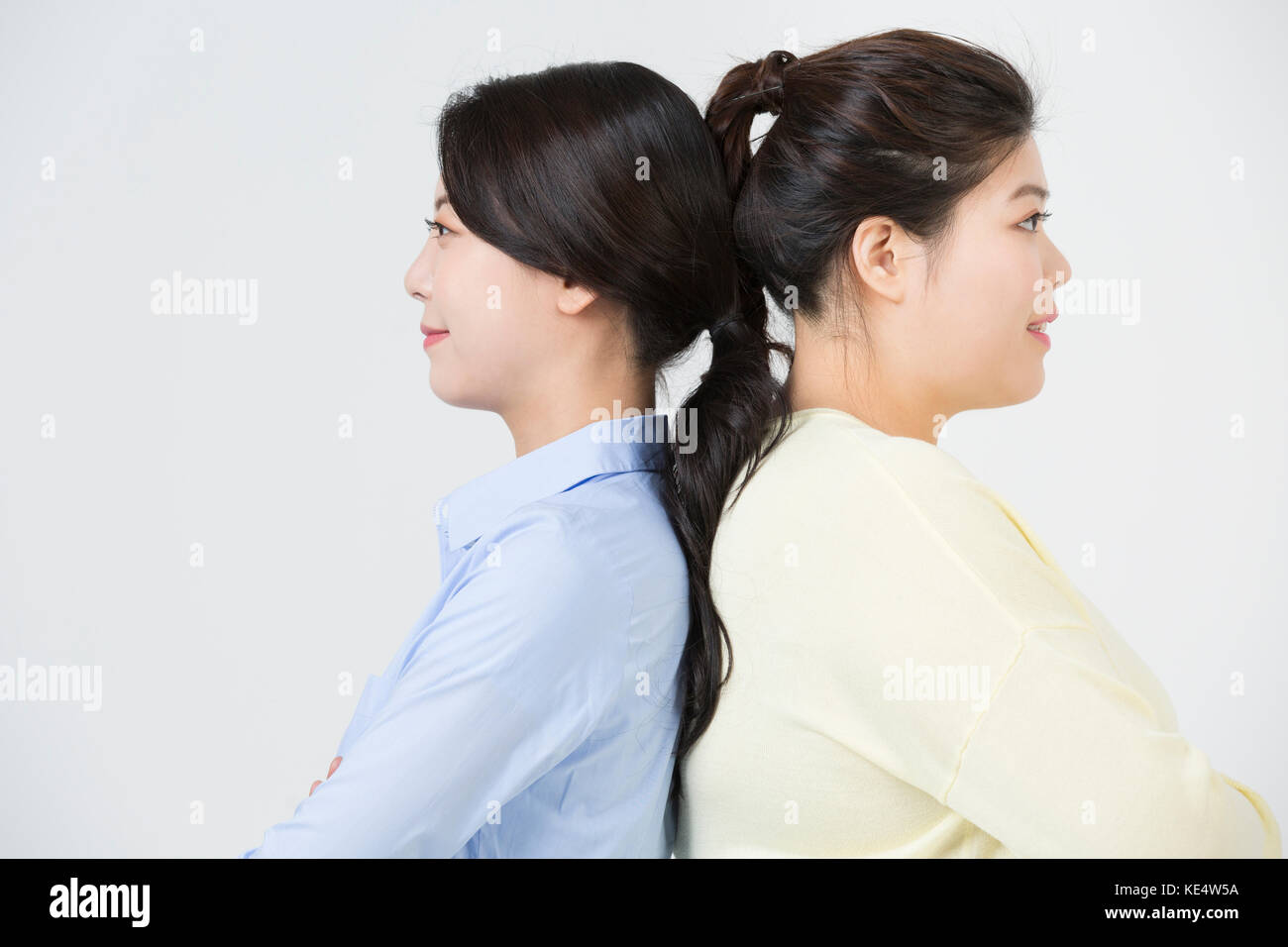 Side view portrait of two smiling women slim and fat Stock Photo - Alamy