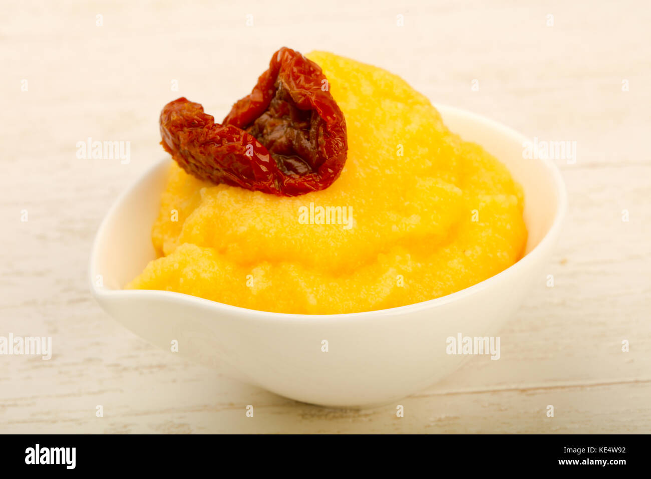 Polenta with dry tomato Stock Photo - Alamy