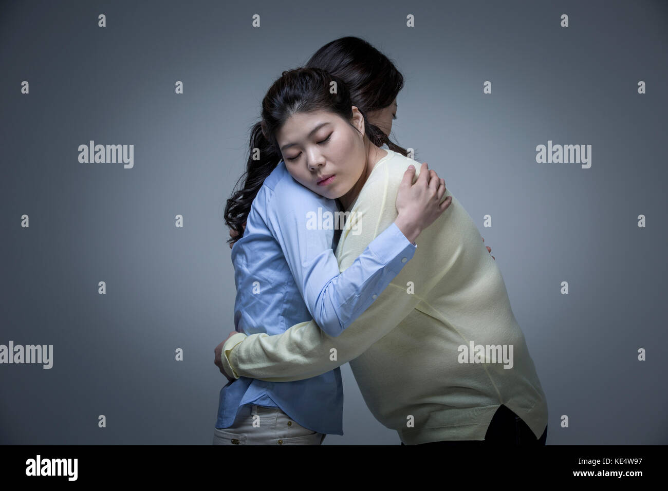 Two women slim and fat hugging each other Stock Photo - Alamy