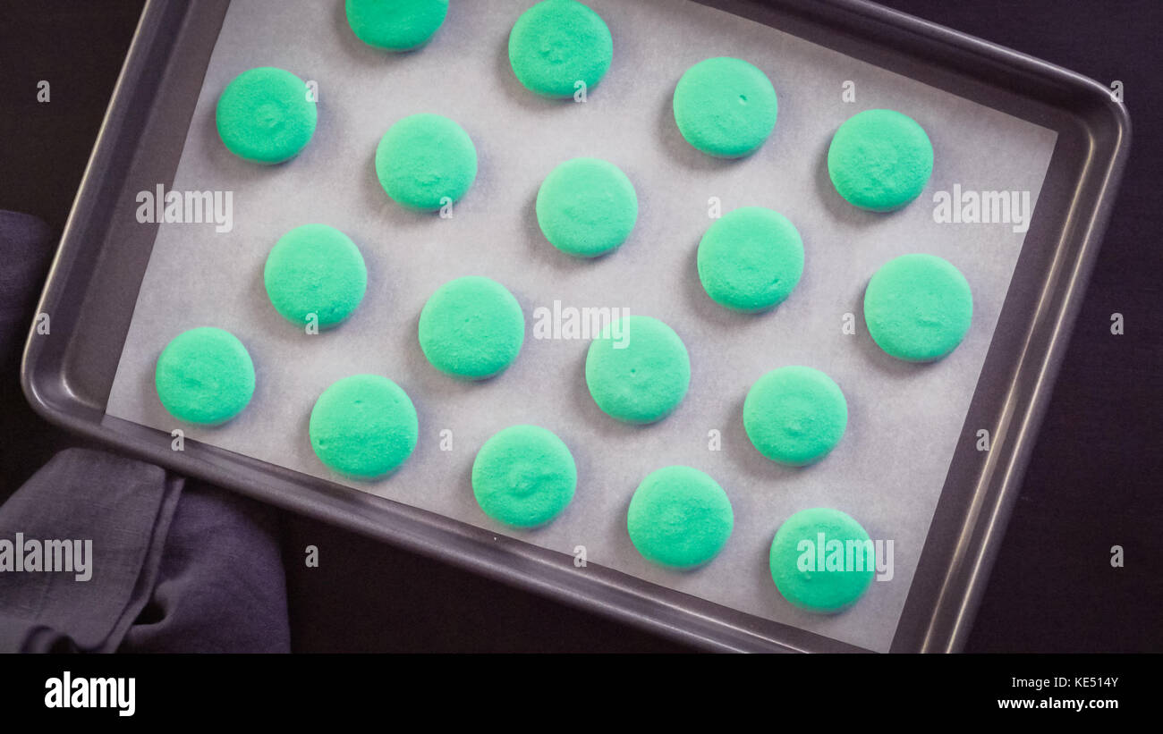 Step by step. Freshly baked macaron shells on baking sheet Stock Photo ...