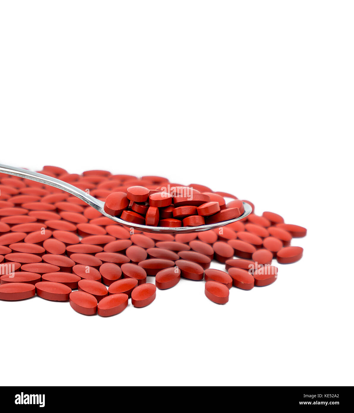 Iron tablets in spoon isolated on white background with copy space for ...