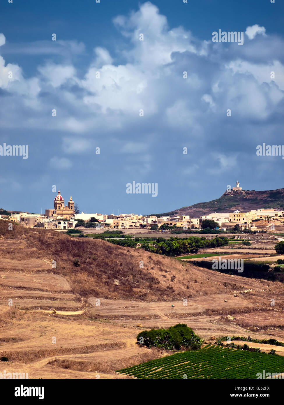 A church in Gozo and its lighthouse at background as seen from the ...