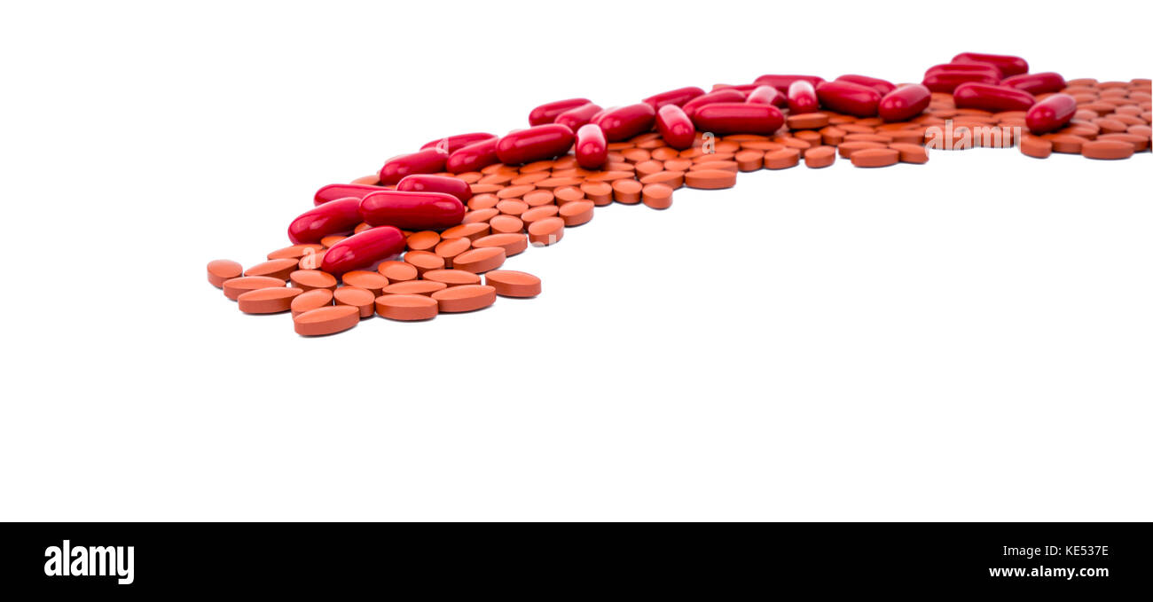 Red vitamins and supplements capsule and iron tablets isolated on white ...