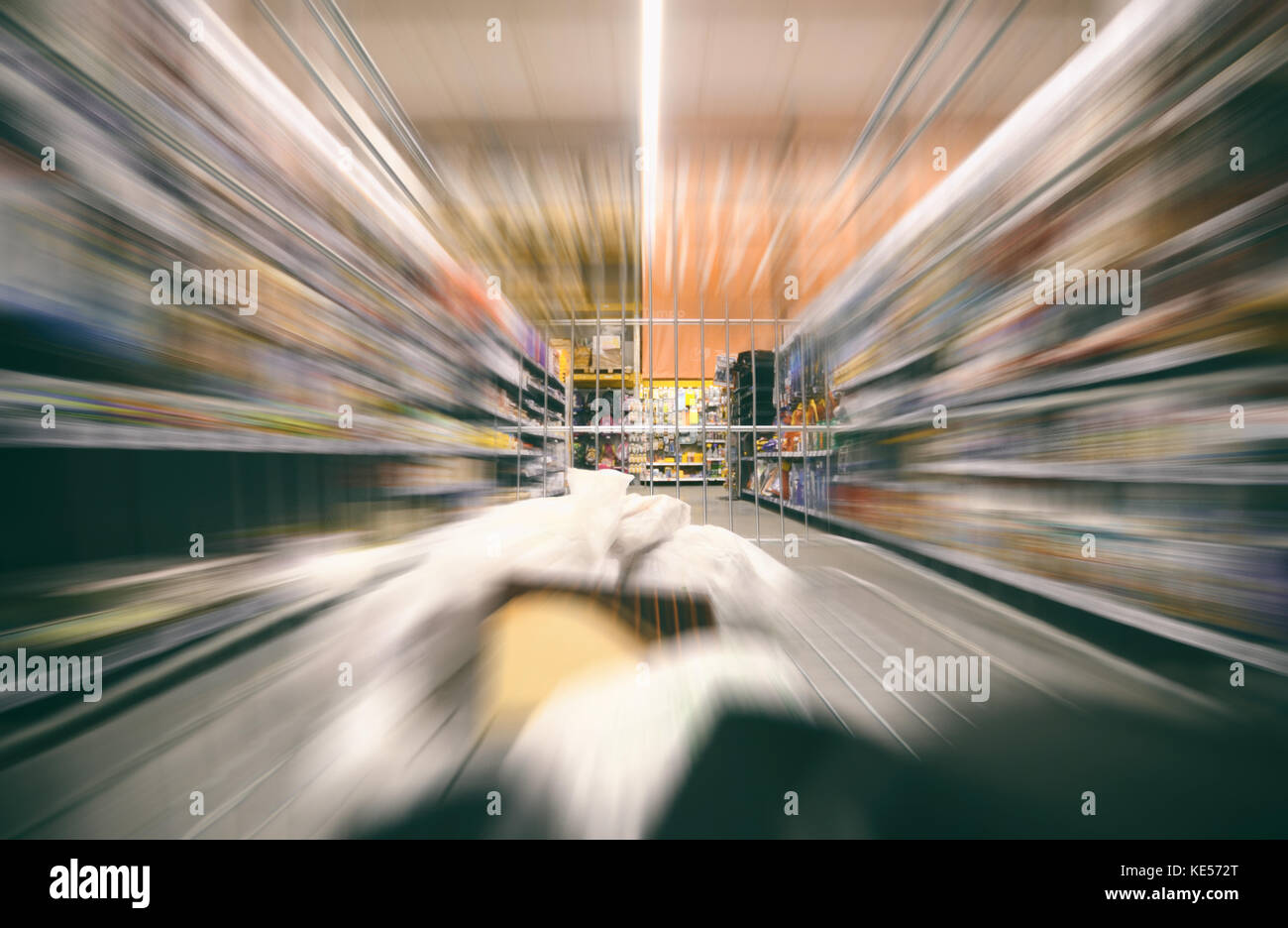 Shopping cart with groceries moving through supermarket, shopping ...