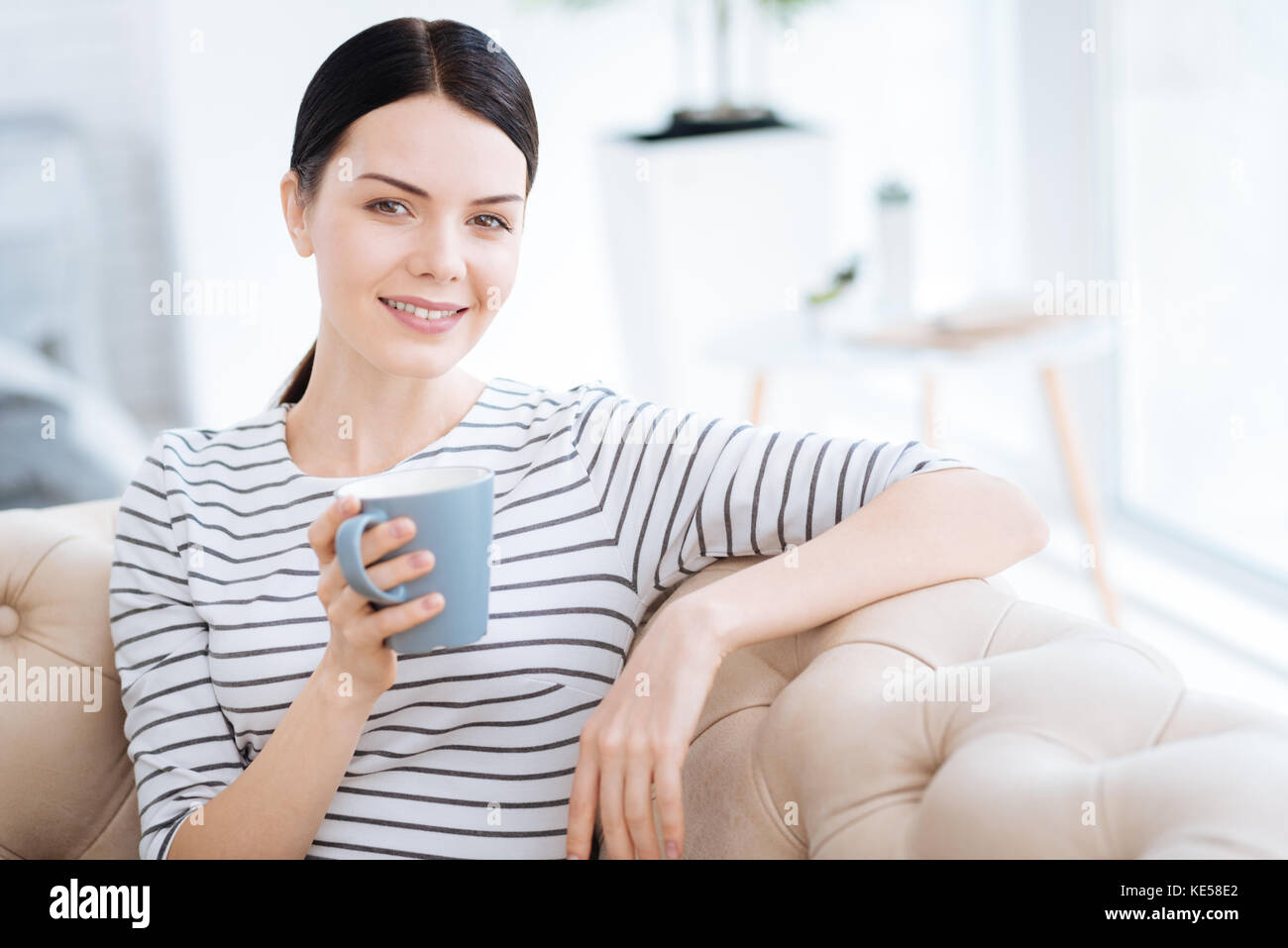 Beautiful pleasant woman resting at home Stock Photo - Alamy