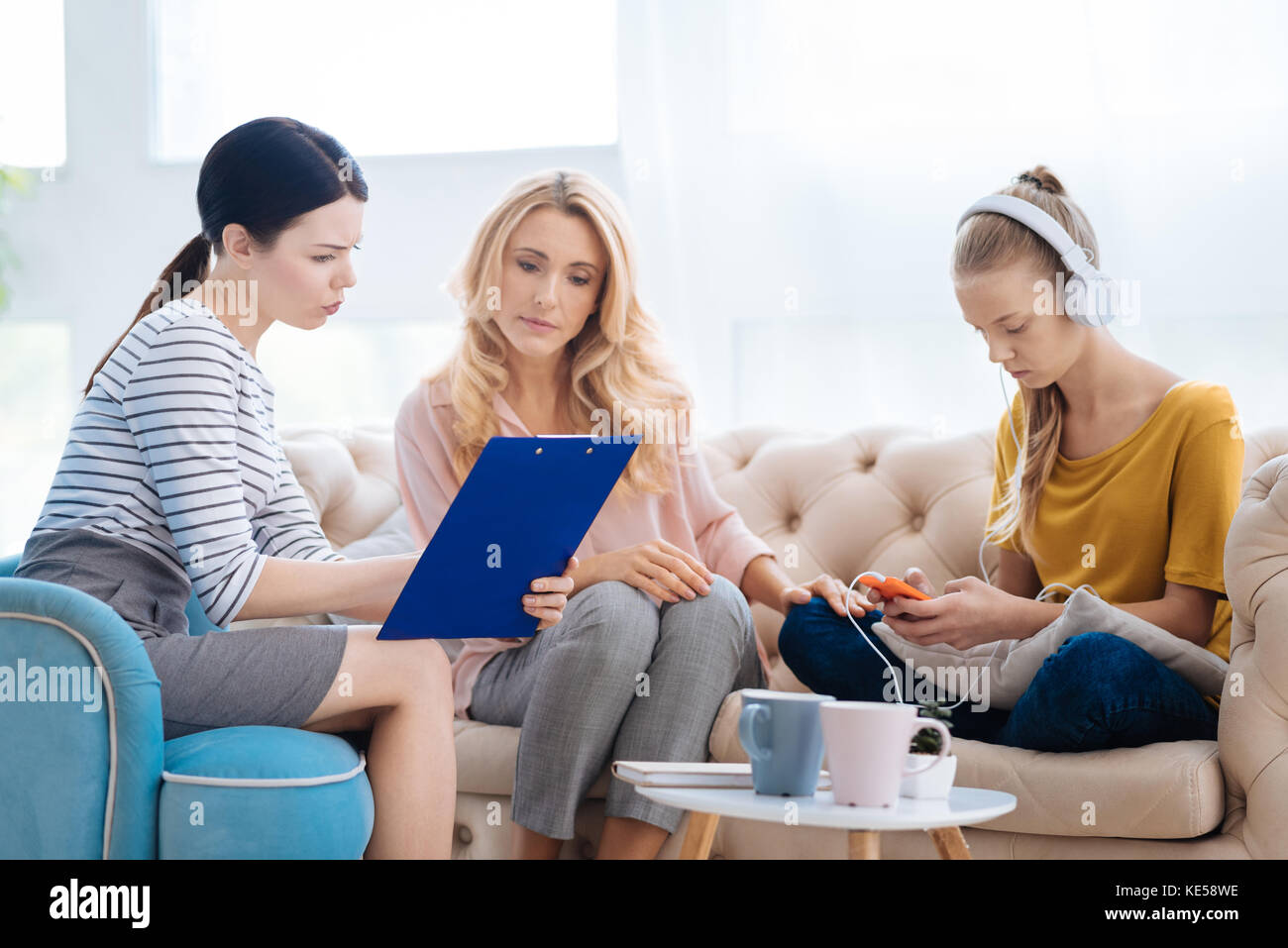 Intelligent professional therapist talking to her patients mother Stock ...