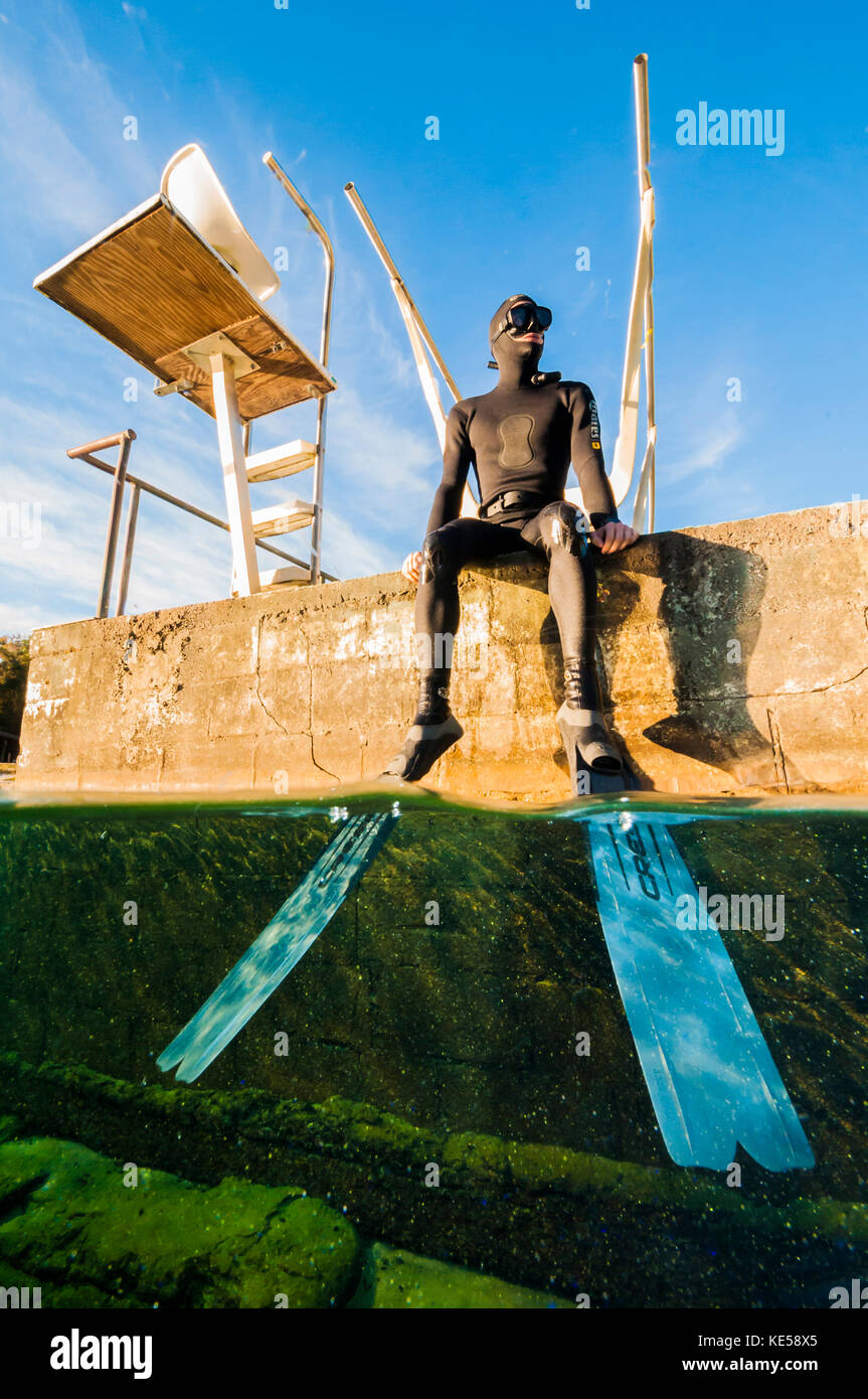 A freediver sits on the side of Jackson Blue Springs before a dive in ...