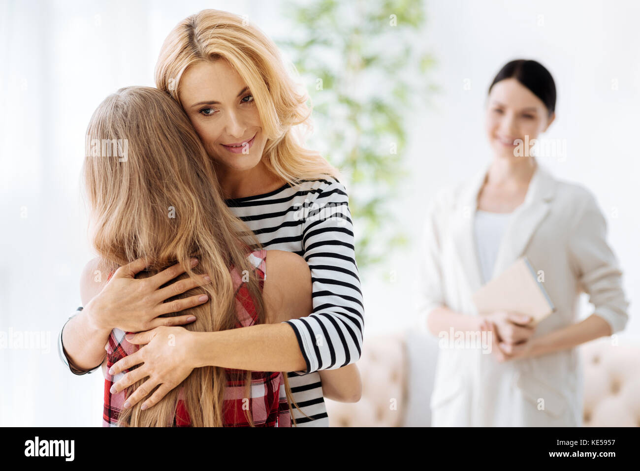 Beautiful caring woman hugging her daughter Stock Photo - Alamy